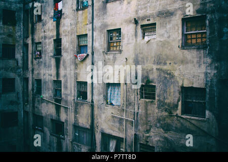 Windows of a condemned building occupied by poor people Stock Photo - Alamy