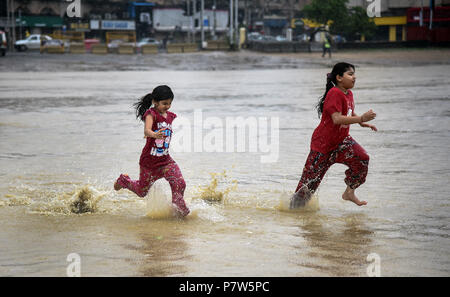 People wade in the water during the Polar Bear Swim in Vancouver ...