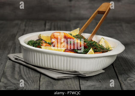 Baked chicken legs with a juicy crust on wooden table Stock Photo - Alamy