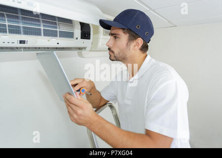 young contractor working carefully and seriously at clients office ...