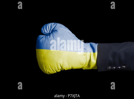 Boxing glove with Ukrainian flag. Boxer holds flag of Ukraine. White ...
