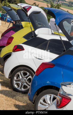 new cars with their boot open on the forecourt of a car dealership ...