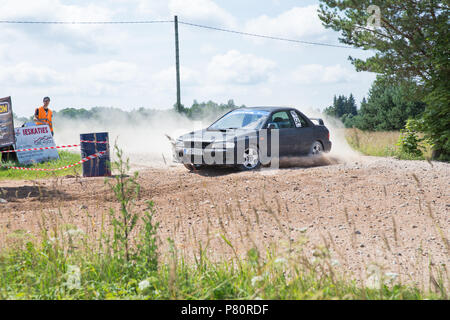 City Livi, Latvia. Amateur rally, dirt road, car with rider. Speed and ...