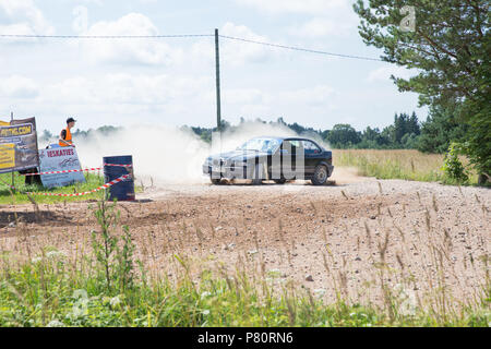 City Livi, Latvia. Amateur rally, dirt road, car with rider. Speed and ...