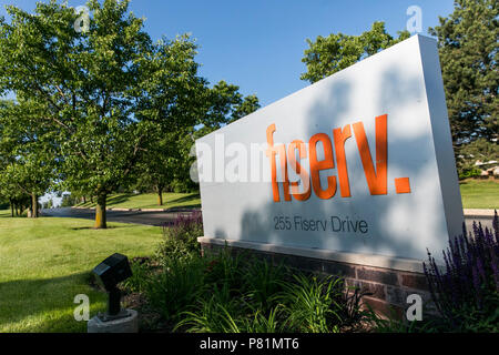 A logo sign outside of the headquarters of Fiserv, Inc., in Brookfield ...