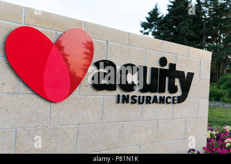 A logo sign outside of the headquarters of Acuity Insurance in ...