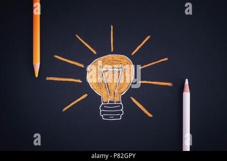 Light bulb with drawing on yellow background. Business idea concept ...