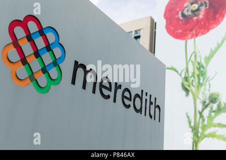 A logo sign outside of the headquarters of the Meredith Corporation in ...