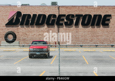 A logo sign outside of the Bridgestone Firestone agricultural tire ...