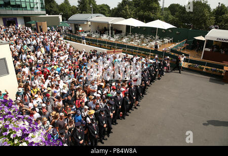 Spectators are led into the grounds on day six of the Wimbledon ...
