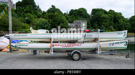 two coastal rowing boats mounted on a trailer in west cork, Ireland ...