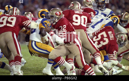 San Francisco 49ers' Carl Monroe scrambles to evade a tackle by ...