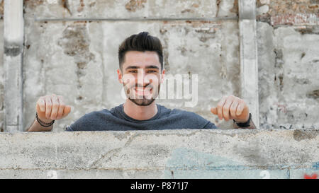 A young man popping his head out of a computer monitor with nerd ...