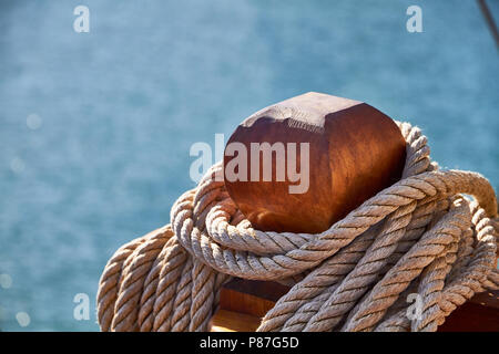 Marine background, sailing boat block with old rope Stock Photo - Alamy