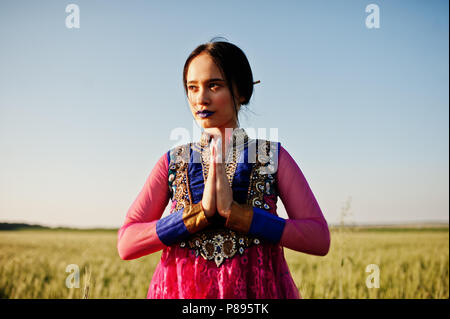 Tender indian girl in saree, with violet lips make up posed at field in ...
