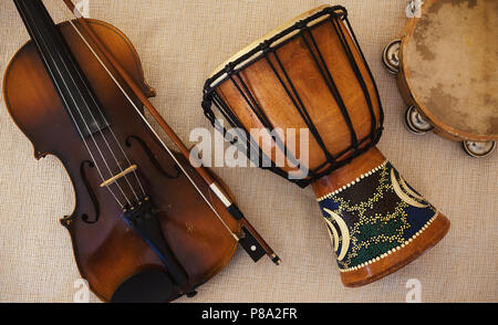 Details of an old and dusty violin from Czechoslovakia and tambourine ...