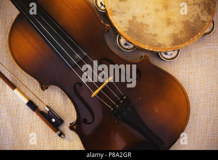 Details of an old and dusty violin from Czechoslovakia and tambourine ...