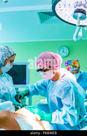 surgeon during liposuction in the operating room Stock Photo - Alamy