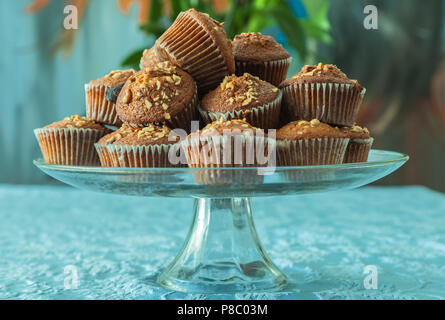 Display of banana walnuts muffins on platter, with half-eaten one on a ...