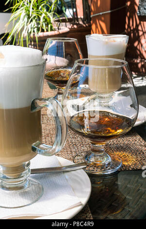 Frothy coffee and brandy on a table of a cafe in Puerto Vallarta ...