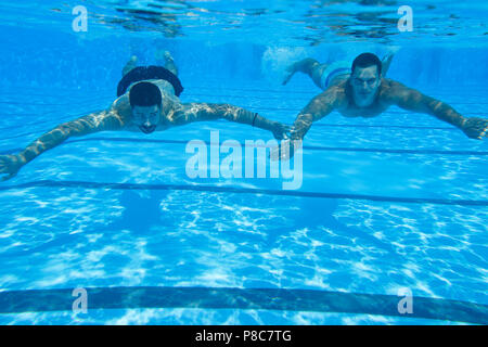 Underwater enjoyment. Two friends having fun underwater in swimming ...