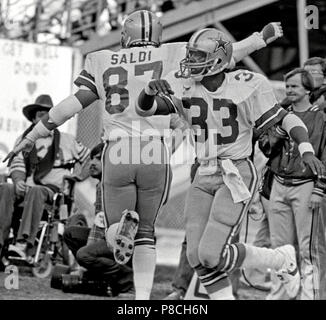 Tony Dorsett, Dallas Cowboys running back, goes up and over a host of ...