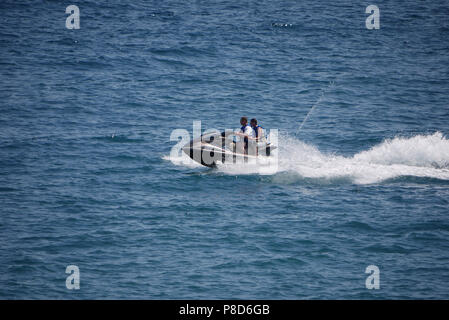 Tourists ride a water motorcycle in the water area of the Sea of Cortez ...