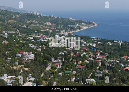 small grass-covered rocks on the background of a beautiful coastal town ...
