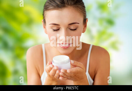 Close up of a lovely woman smelling scented candle in shop Stock Photo ...