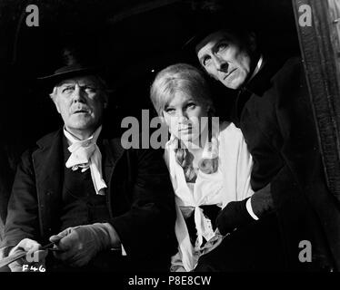 THORLEY WALTERS, SUSAN DENBERG and PETER CUSHING in a scene from ...