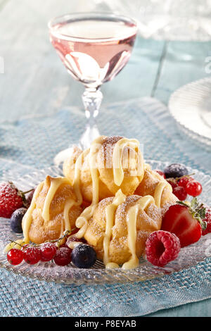 Raspberries Profiteroles with White Chocolate Cream Stock Photo - Alamy