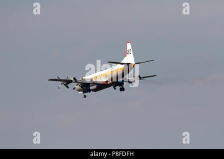 Lockheed L-188 Electra water bomber in flight to drop load on BC forewt ...