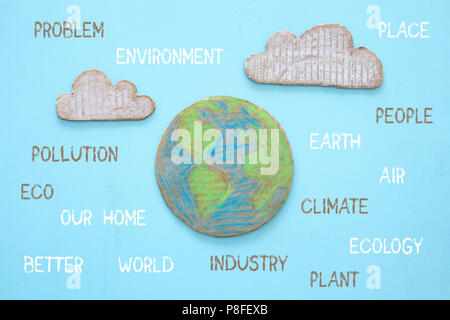 top view image of cardboard earth globe over blue wooden background ...