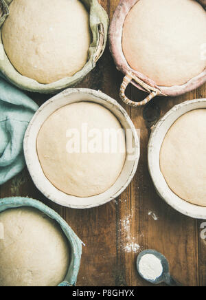 Flat lay of Wheat flour in wooden bowl with wheat spikelets on colored ...