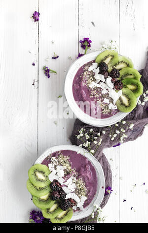 Healthy smoothie for breakfast, kiwi, chia, flakes and green vegetables ...