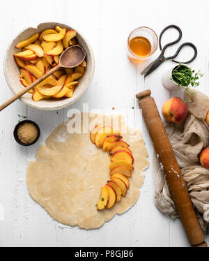Peach galette, pie, cake with honey and berry on a wooden background ...