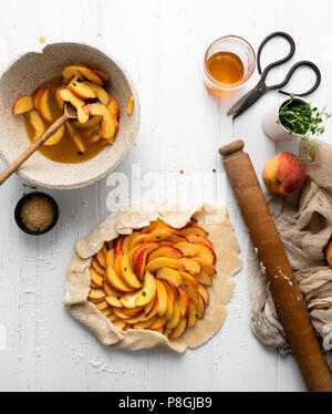 Peach galette, pie, cake with honey and berry on a wooden background ...