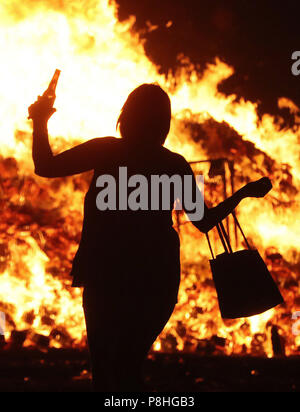 People attend an 11th night Bonfire in the Sandy Row area of Belfast ...