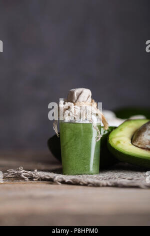 Avocado facial scrub on a wooden surface. Closeup Stock Photo - Alamy