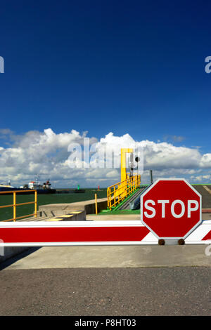 Stop sign on the road of loading on the ferry in the terminal of the ...