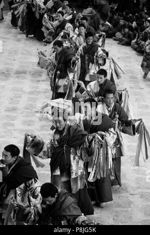 Monks dance with ribbons representing deity powers at the Monlam Chenmo ...