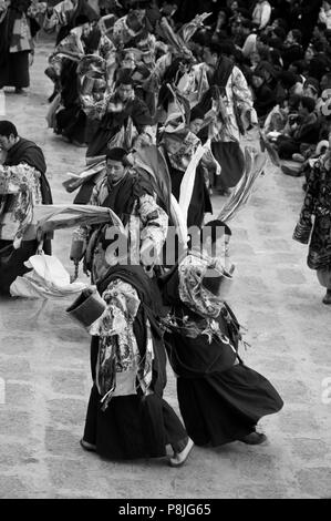 Monks dance with ribbons representing deity powers at the Monlam Chenmo ...