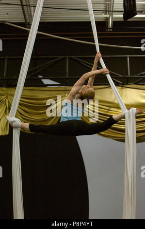 Acrobat performing in front of black background Stock Photo - Alamy