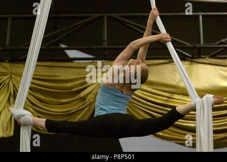 Acrobat performing in front of black background Stock Photo - Alamy