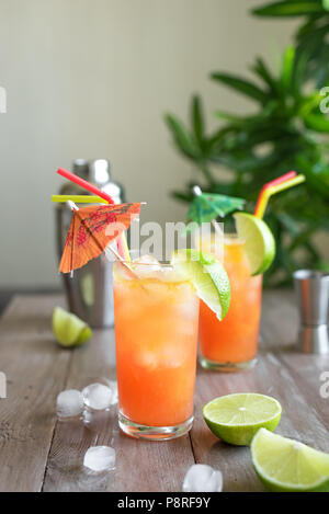 Zombie Cocktail with Rum, garnished with lime. Cold sweet summer fruit ...