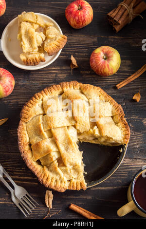 Piece of homemade apple pie with cinnamon and cup of tea on white ...
