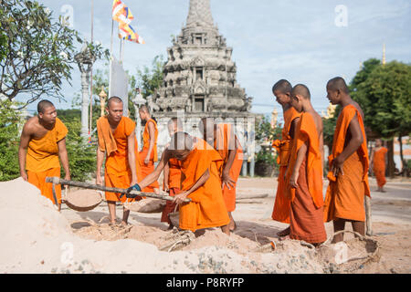 young monks wort at a construction for a new building at the Wat ...