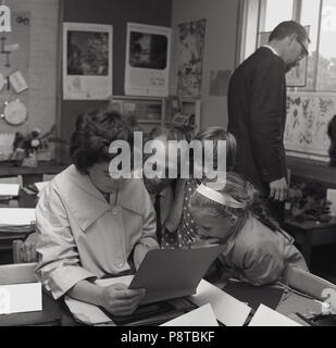 1960s, historical, a female primary school teacher with children in the ...