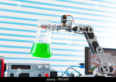 Robotic arm holding flask Stock Photo - Alamy