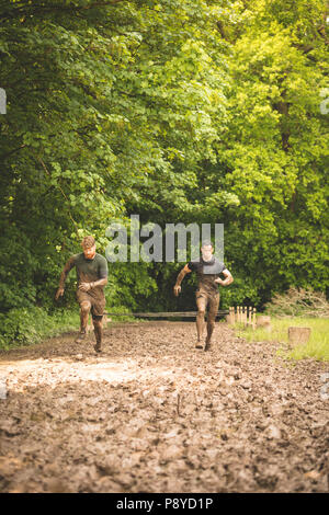 team running boot camp obstacle course Stock Photo - Alamy
